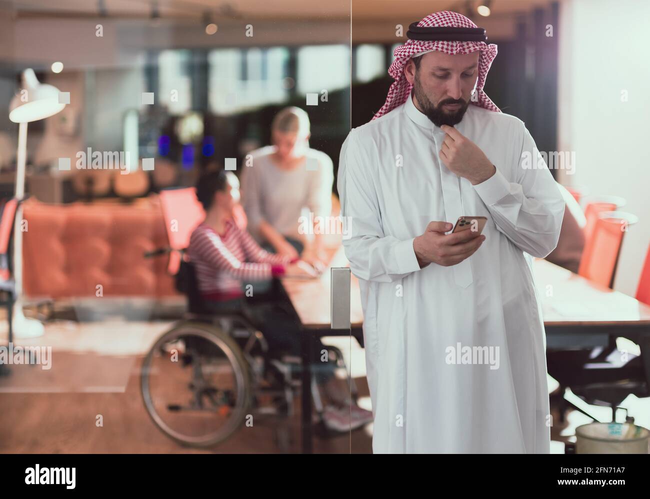 Middle eastern Arab businessman in the office speaking on smartphone in ...