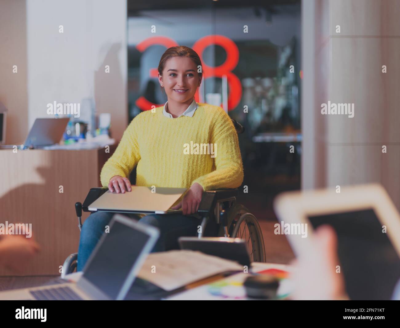 Handicapperd businesswoman in a wheelchair on meeting with her diverse ...