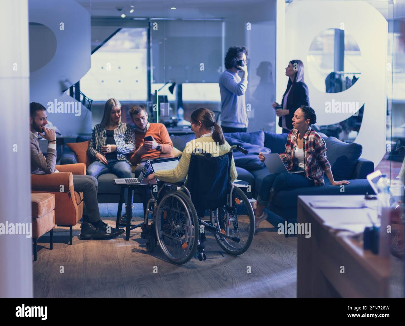 Handicapperd businesswoman in a wheelchair on meeting with her diverse ...