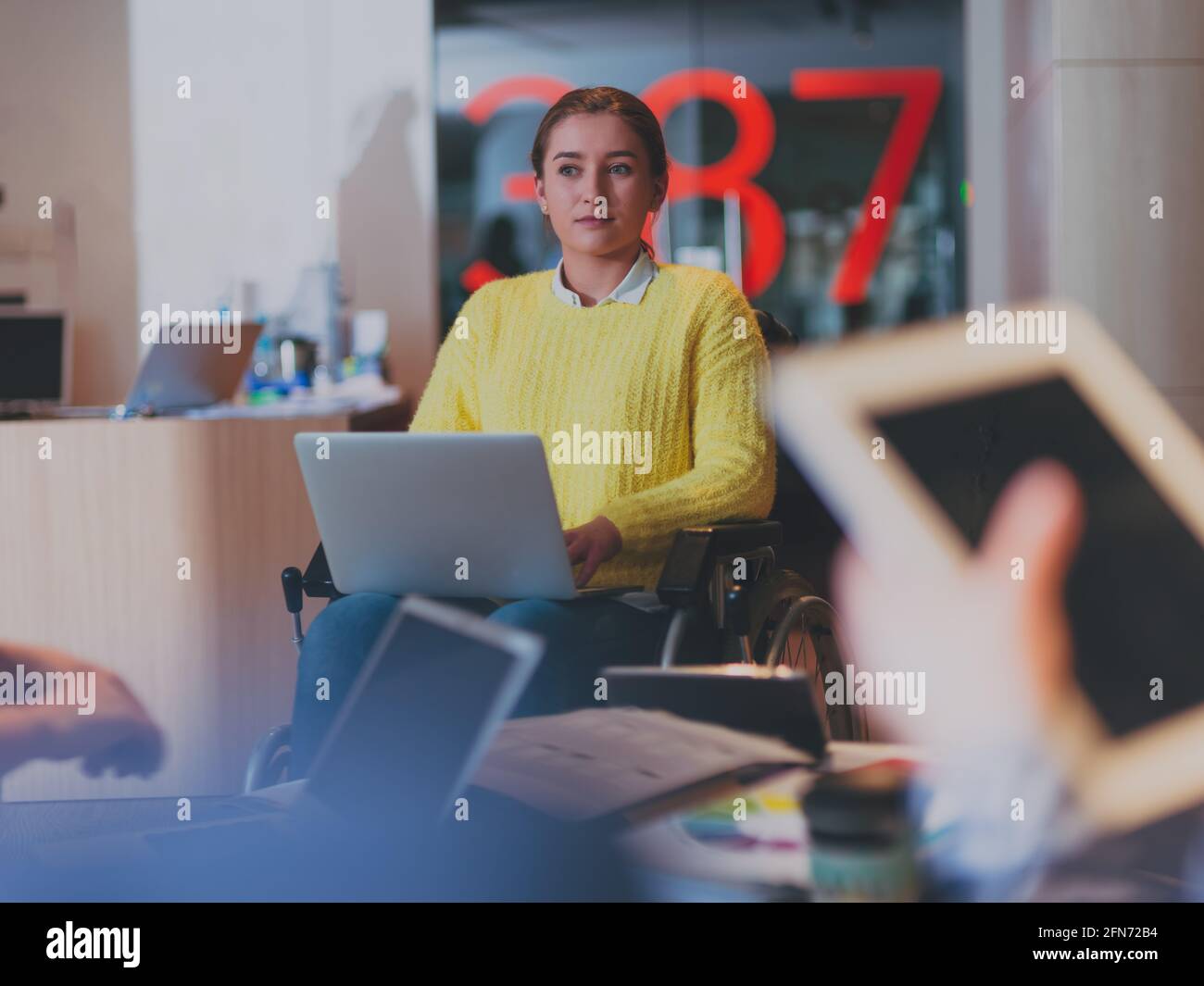 Handicapperd businesswoman in a wheelchair on meeting with her diverse ...