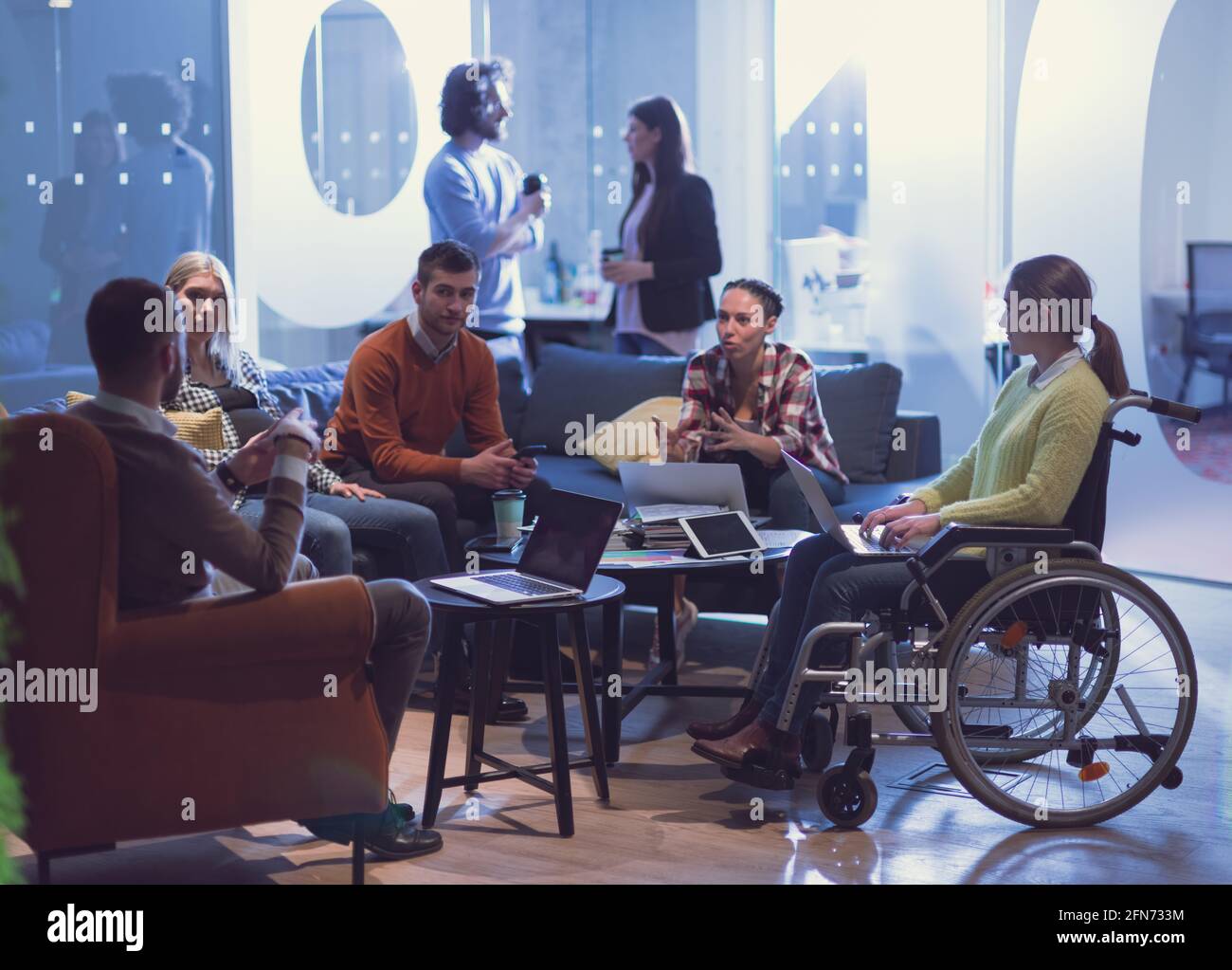 Handicapperd businesswoman in a wheelchair on meeting with her diverse ...