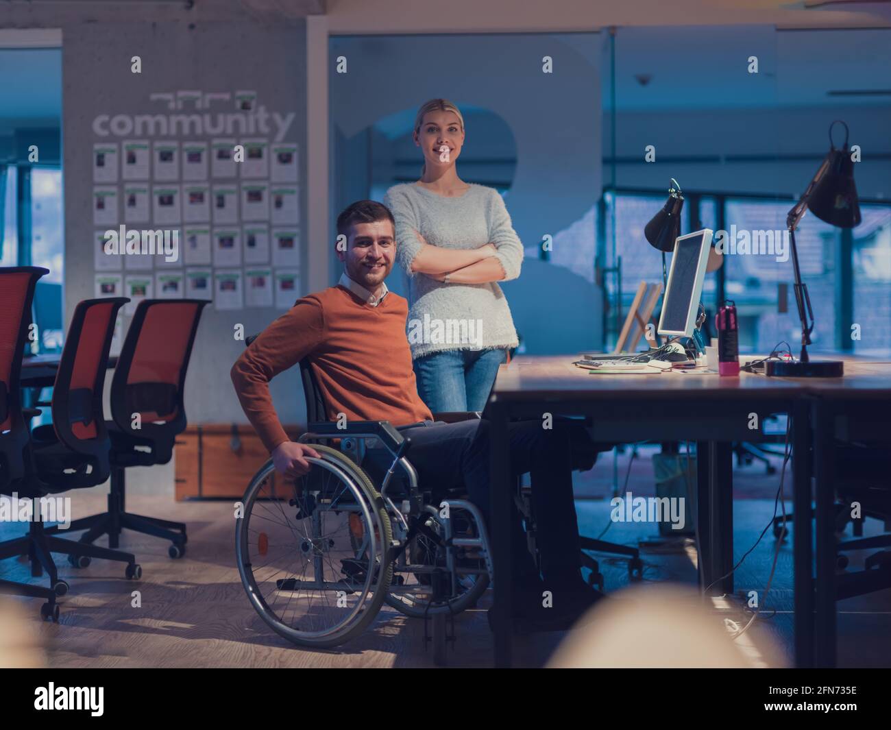 Businessman in a wheelchair in modern coworking office space working ...