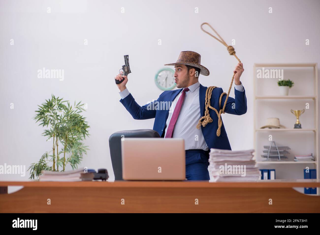 Young cowboy employee working at workplace Stock Photo - Alamy