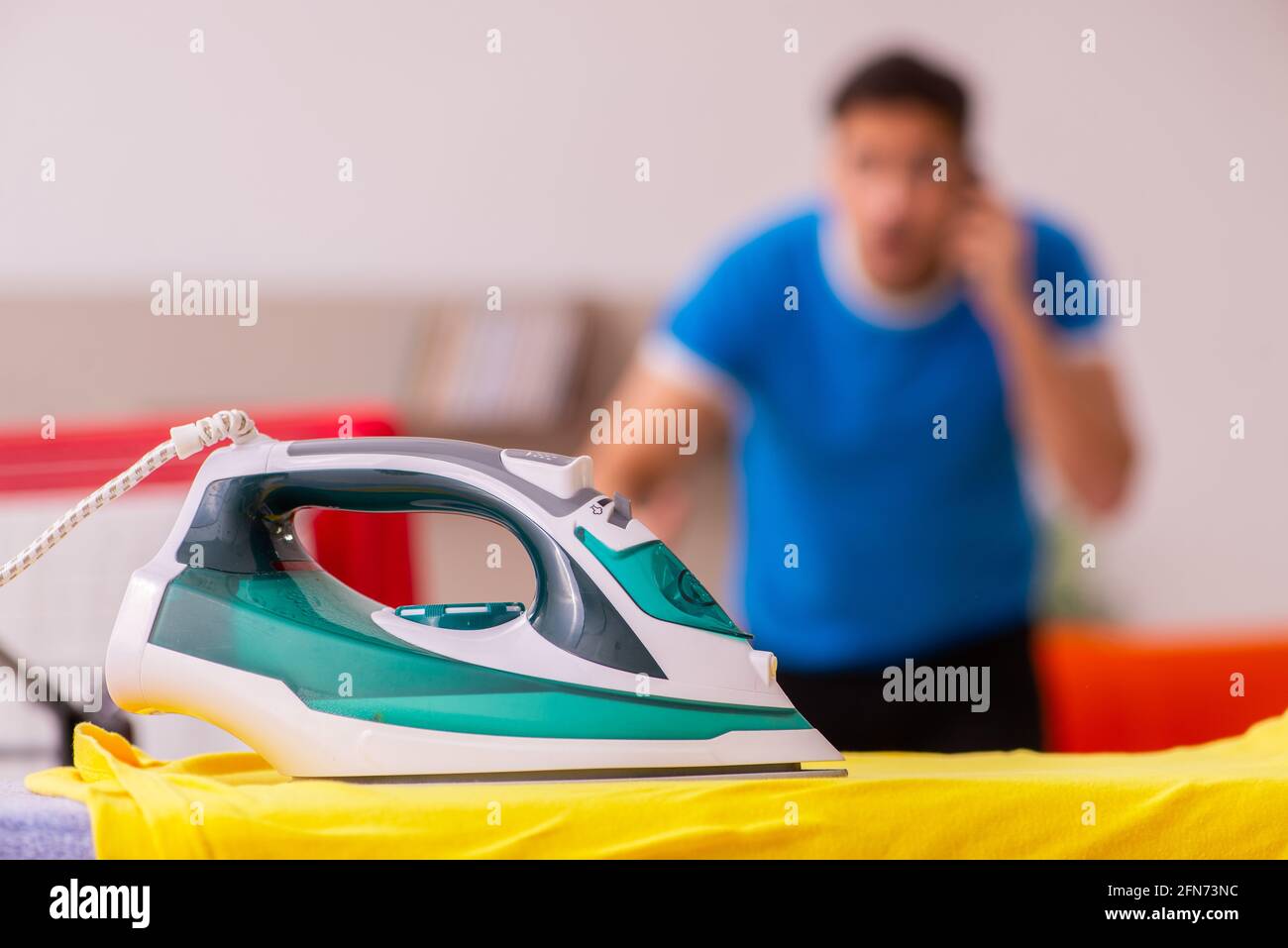 Man ironing panic hi-res stock photography and images - Alamy