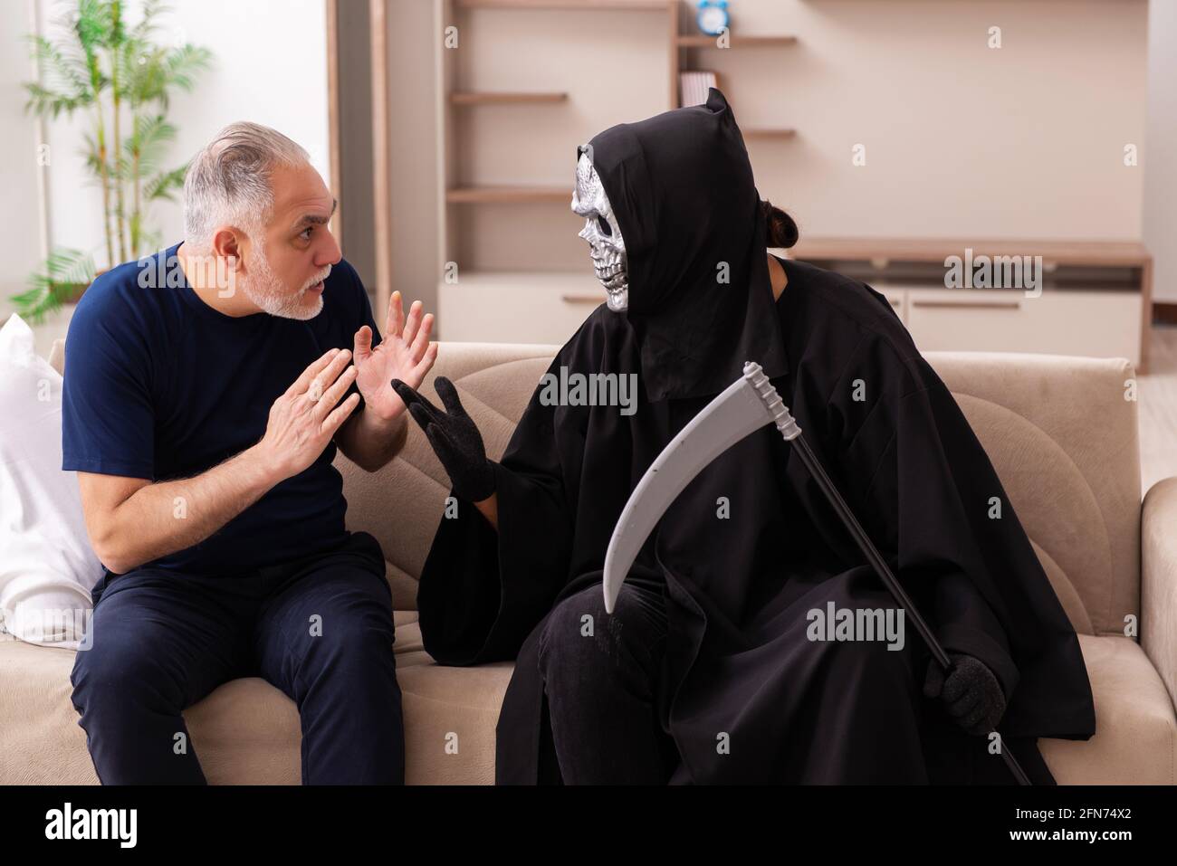Devil coming to old dying man Stock Photo - Alamy