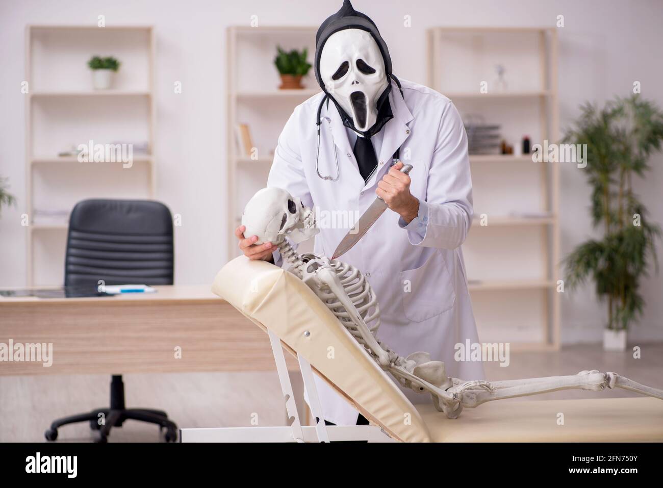 Devil doctor examining skeleton patient in the clinic Stock Photo - Alamy