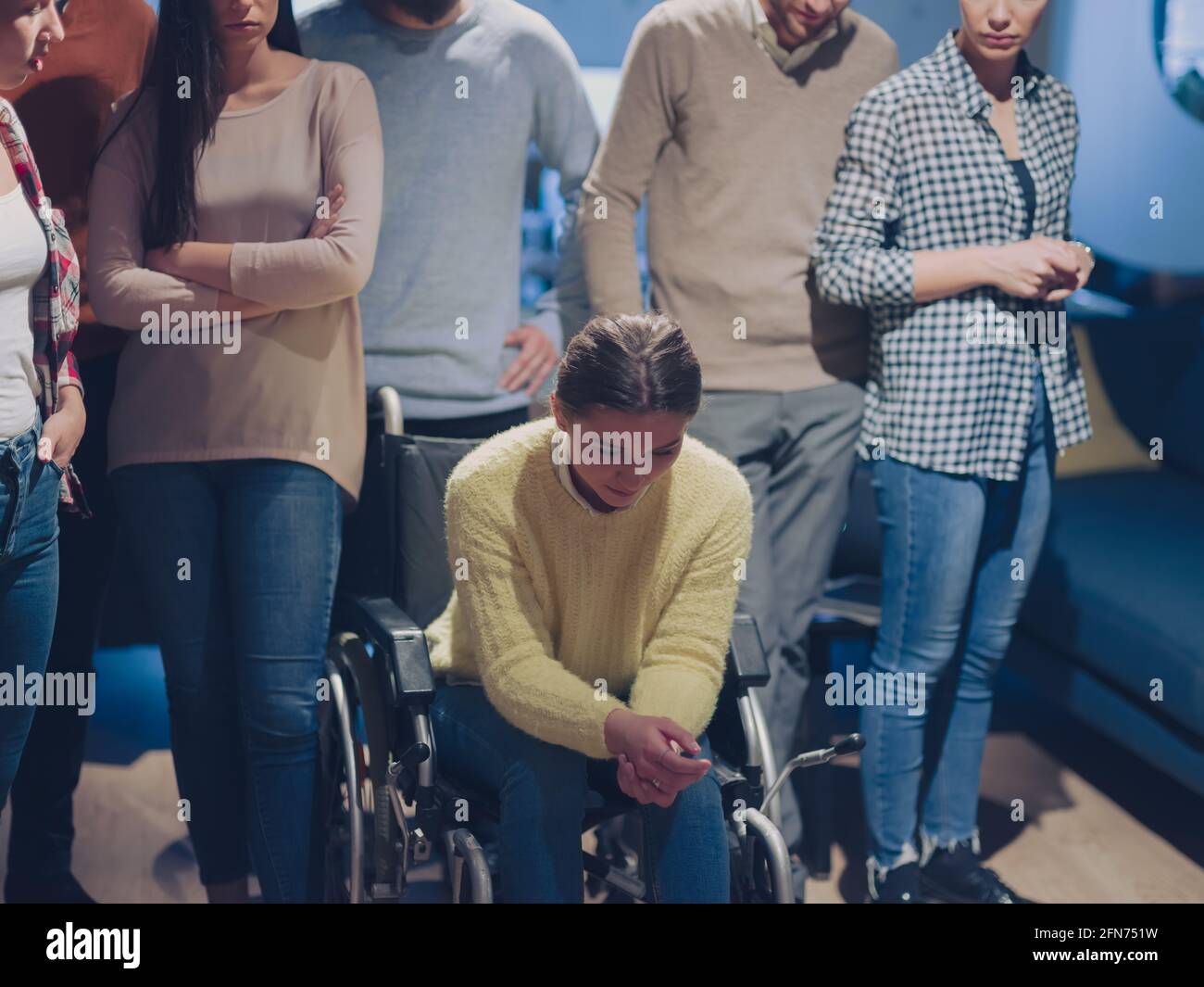 Sad and depressed disabled businesswoman in a wheelchair at the office ...