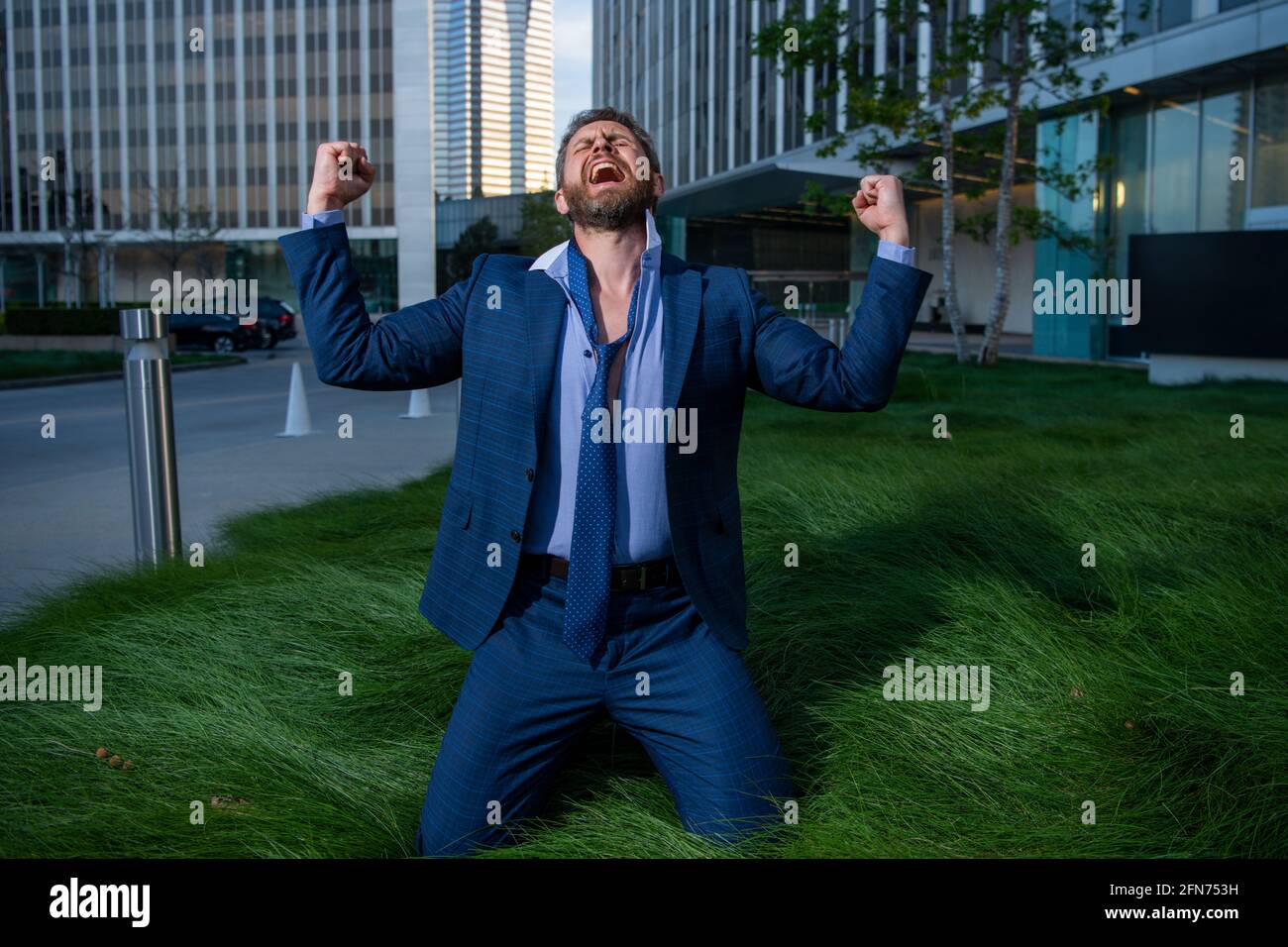 Business man crying in depression sitting on ground street suffering ...