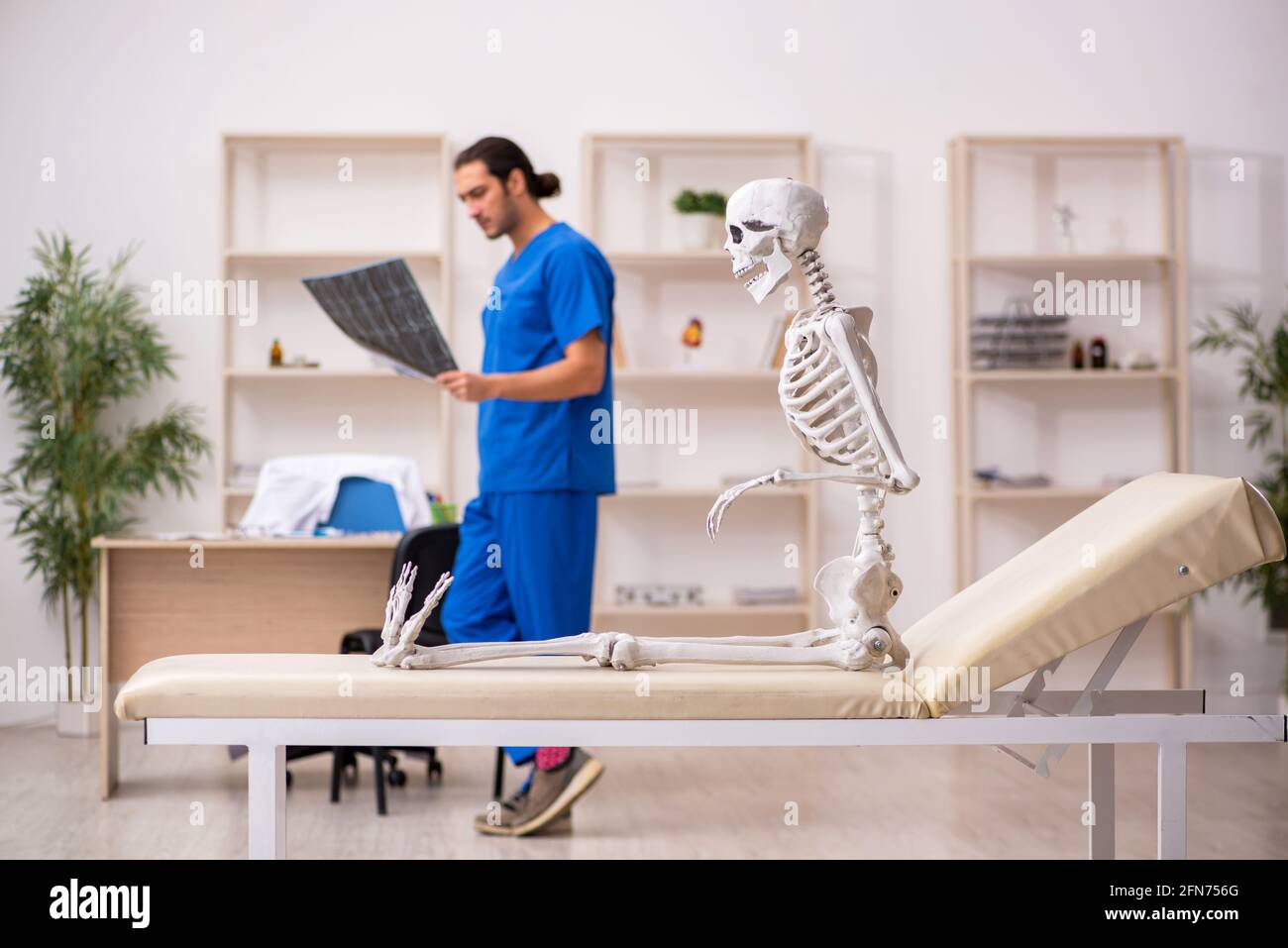 Young doctor radiologist and skeleton patient in the clinic Stock Photo ...