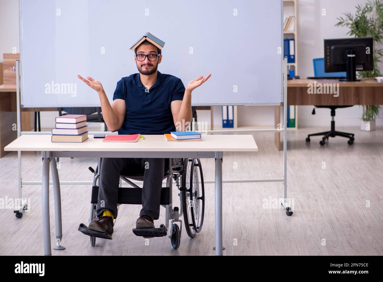 Young handicapped student in the classroom Stock Photo - Alamy