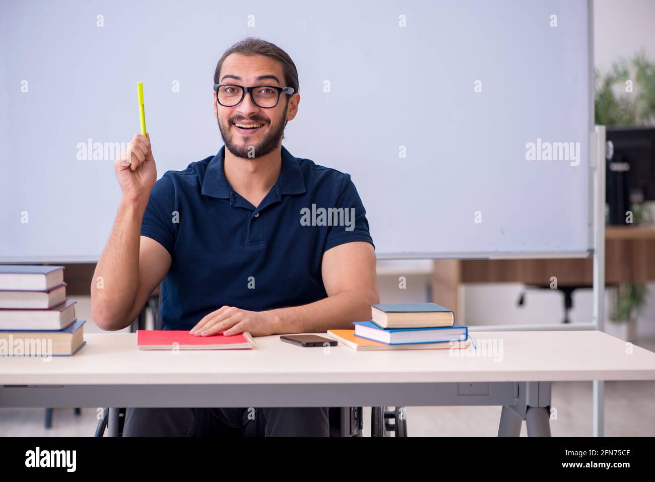 Young handicapped student in the classroom Stock Photo - Alamy