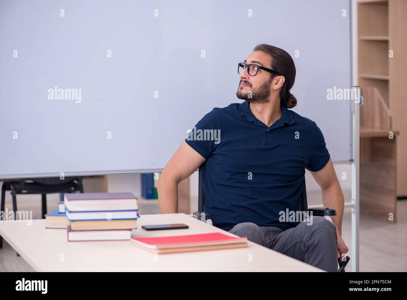 Young handicapped student in the classroom Stock Photo - Alamy