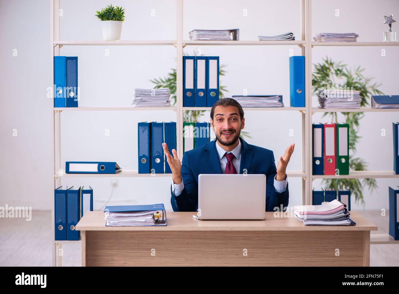 Young employee and too many work in the office Stock Photo - Alamy