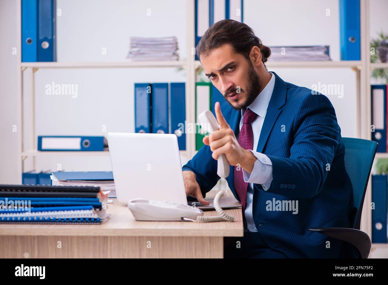 Young employee and too many work in the office Stock Photo - Alamy