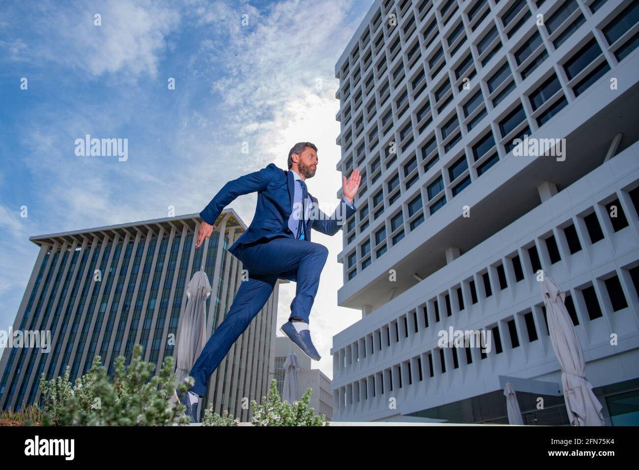 Business man running fast in a city street on urban background Stock ...