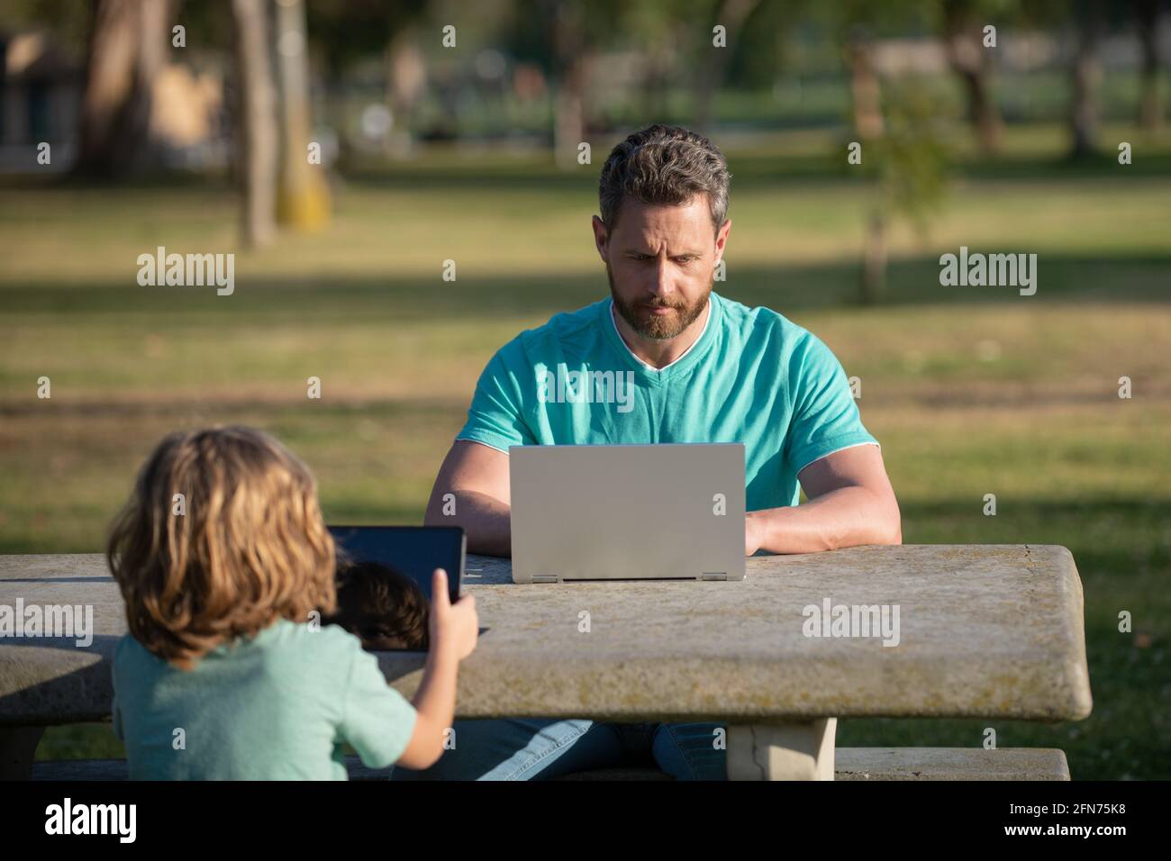 Son with daddy learning lesson. Blogging. Family education Concept ...
