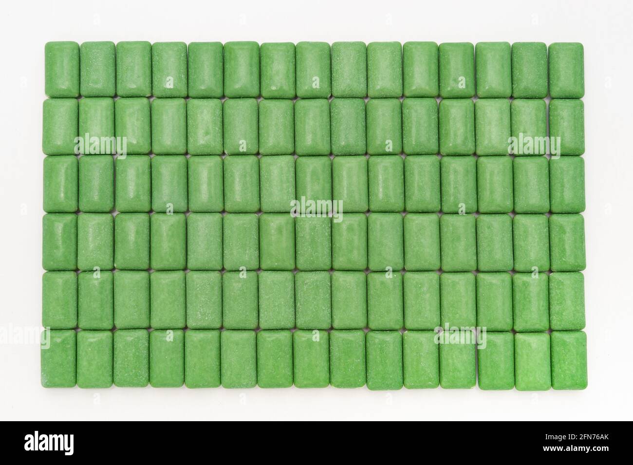 Green mint chewing gum tablets aligned. Isolated on white background ...