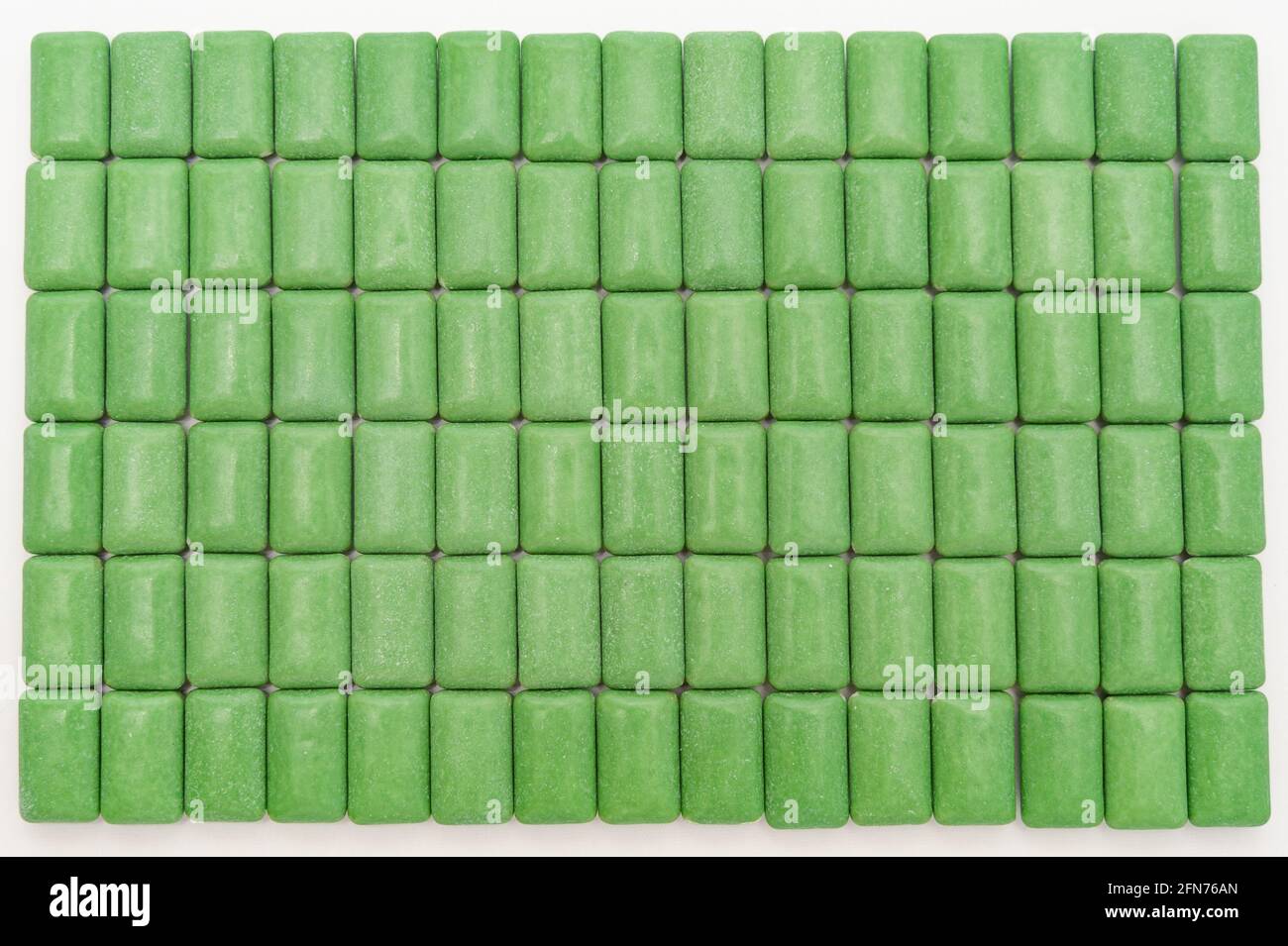 Green mint chewing gum tablets aligned. Isolated on white background ...