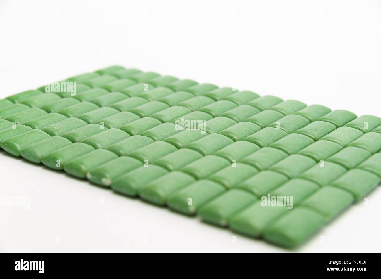 Green mint chewing gum tablets aligned. Isolated on white background ...