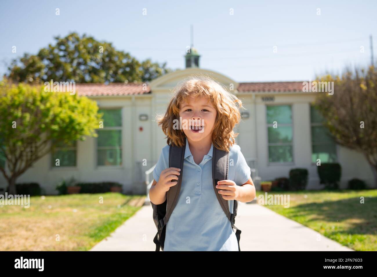 Funny school boy face. Child pupul with rucksacks in the park near ...