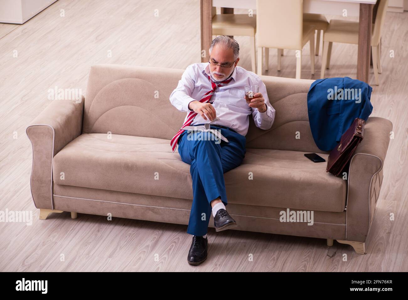 Senior male boss employee coming home from work Stock Photo - Alamy