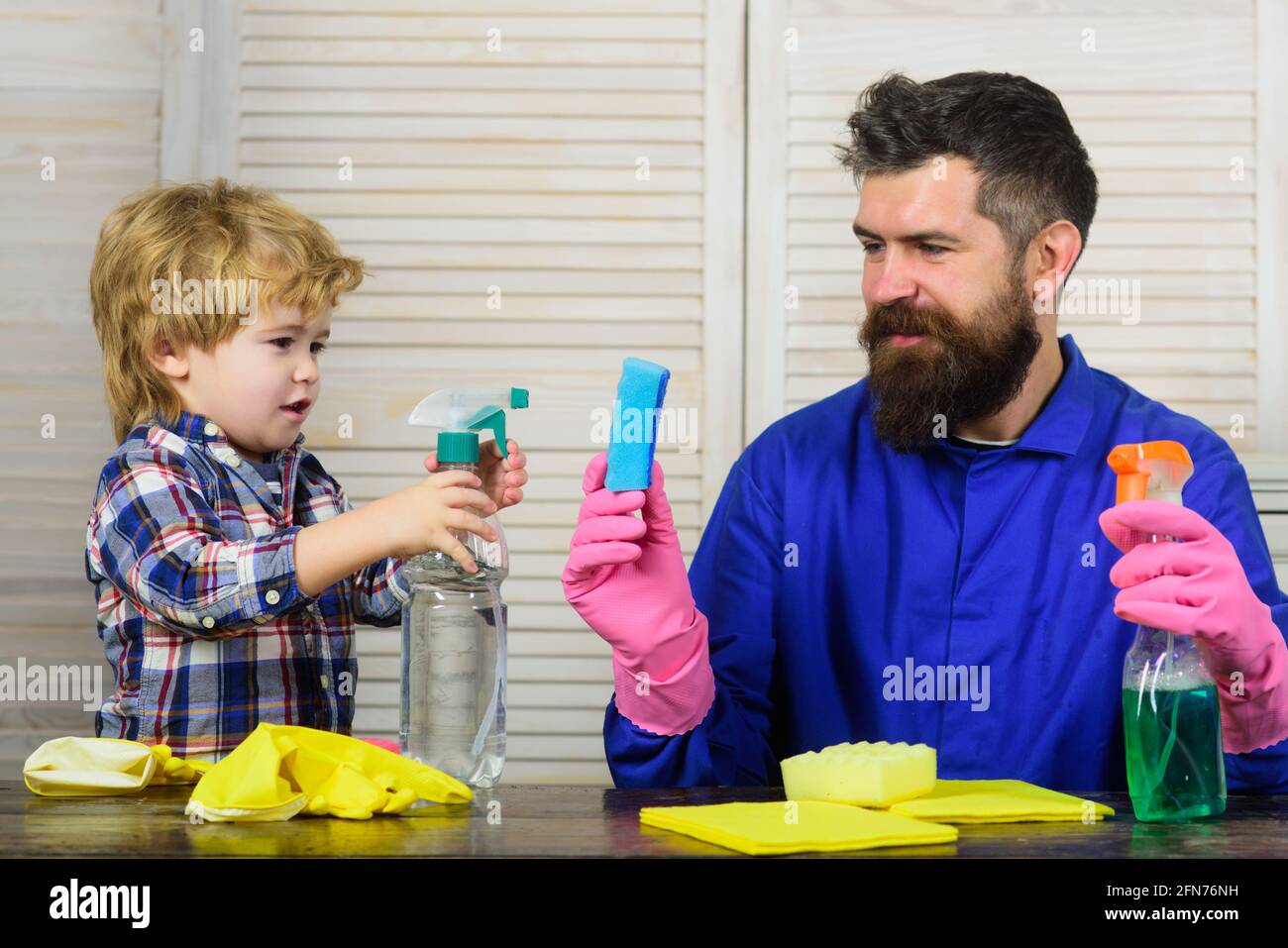 Father is Teaching a son a clean. Cute boy and his dad doing cleaning ...