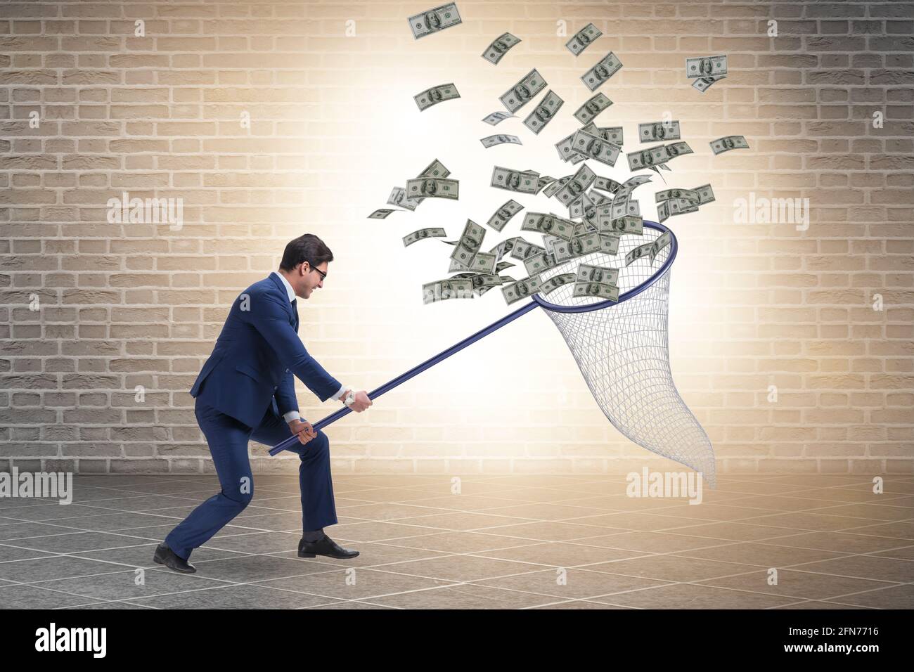 Young businessman catching dollars with the landing net Stock Photo - Alamy