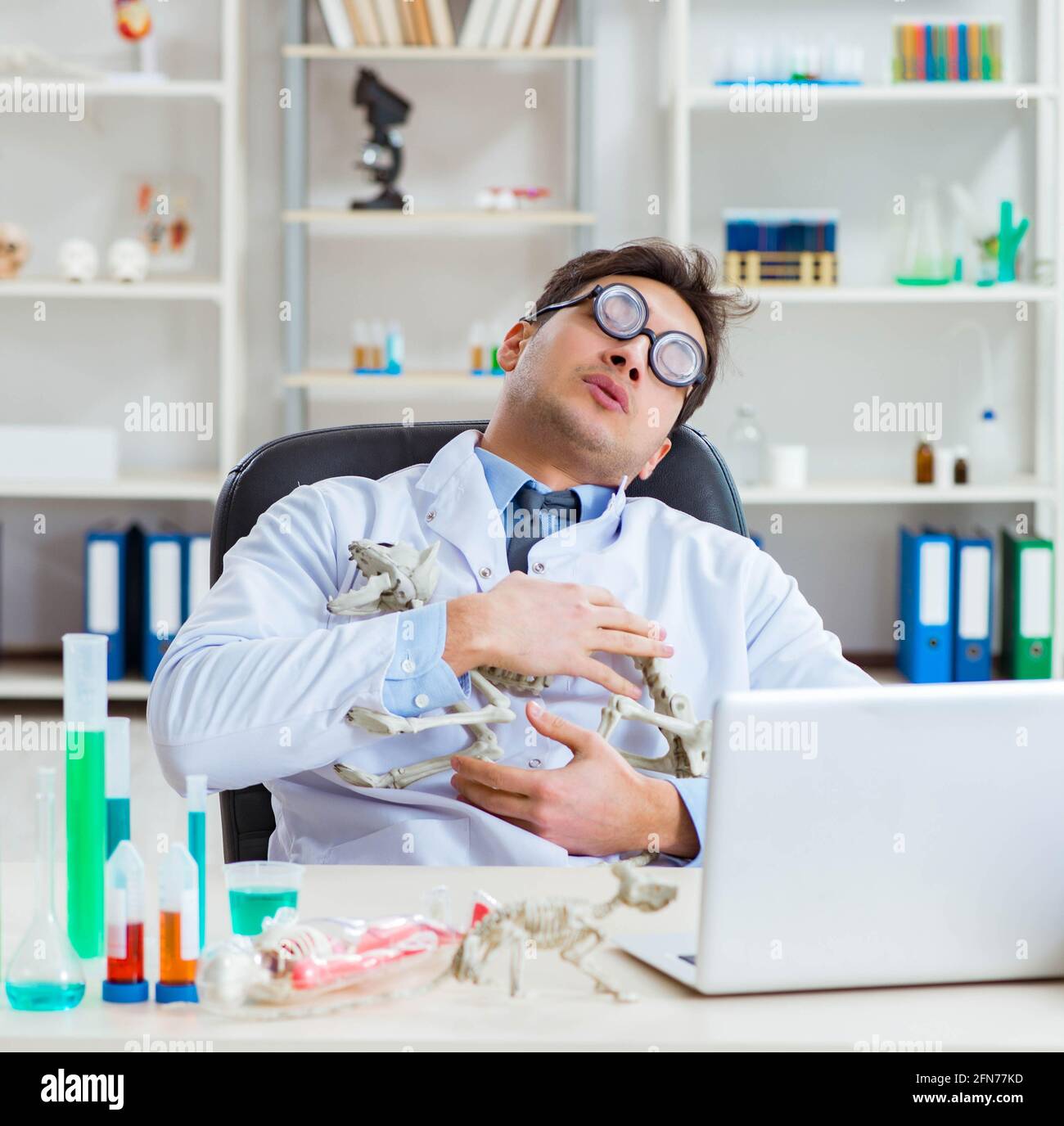 The funny scientist with cat skeleton in lab clinic Stock Photo - Alamy
