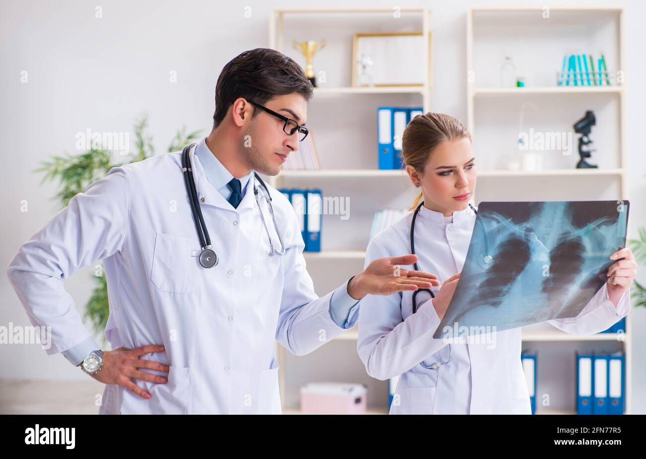 The two doctors examining x-ray images of patient for diagnosis Stock ...