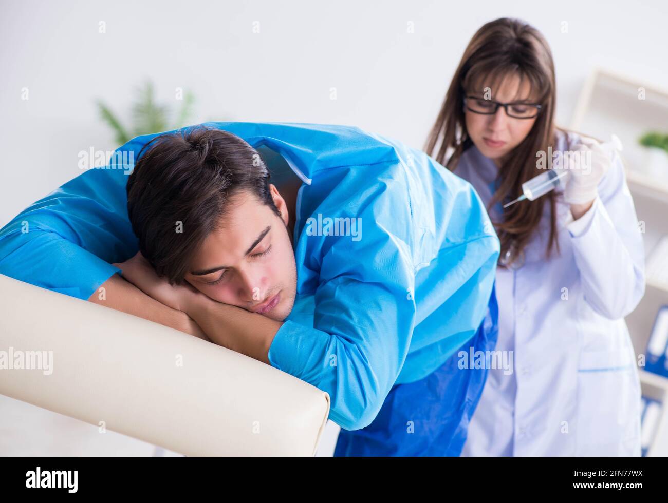 The funny man getting ready for buttocks syringe shot Stock Photo - Alamy