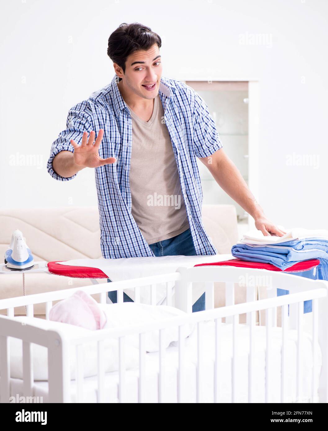 The young dad looking after newborn baby Stock Photo - Alamy