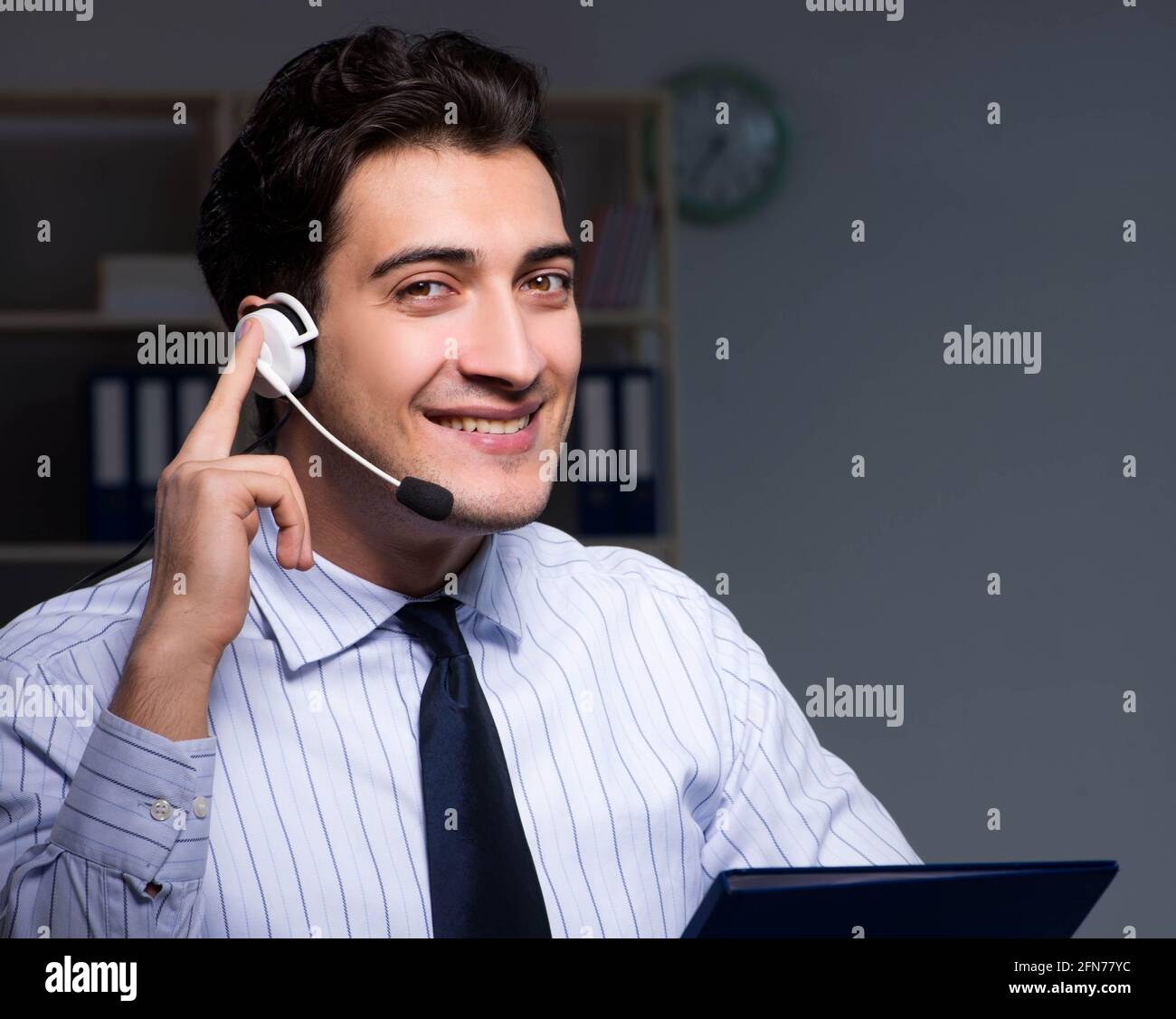 The call center operator talking to customer during night shift Stock ...