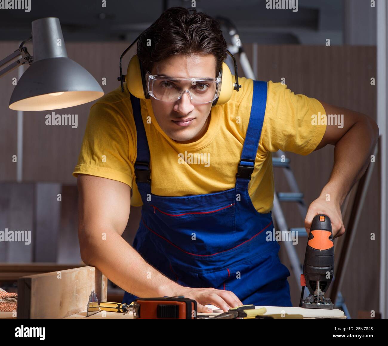 The worker working in repair workshop in woodworking concept Stock ...