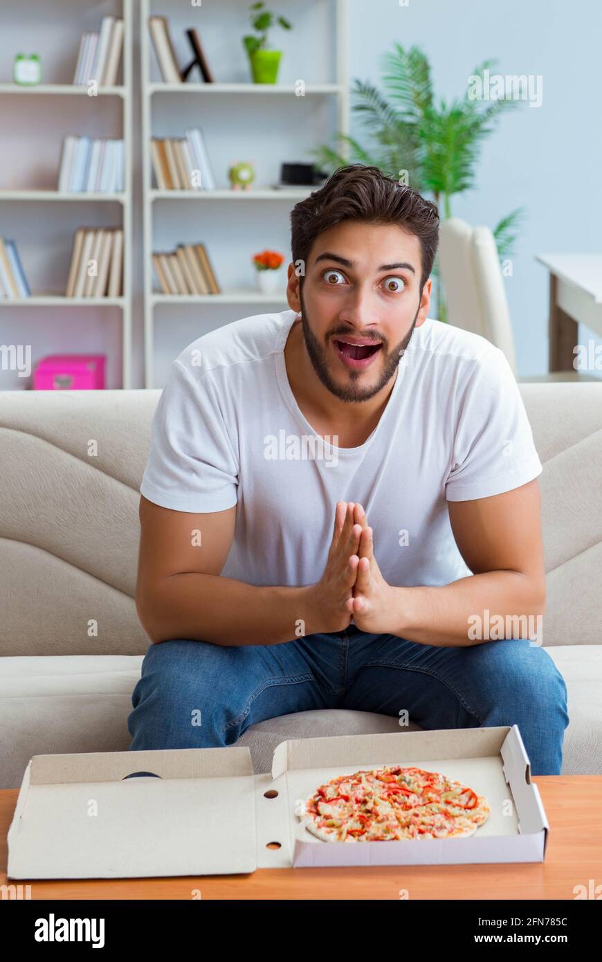 The man eating pizza having a takeaway at home relaxing resting Stock ...