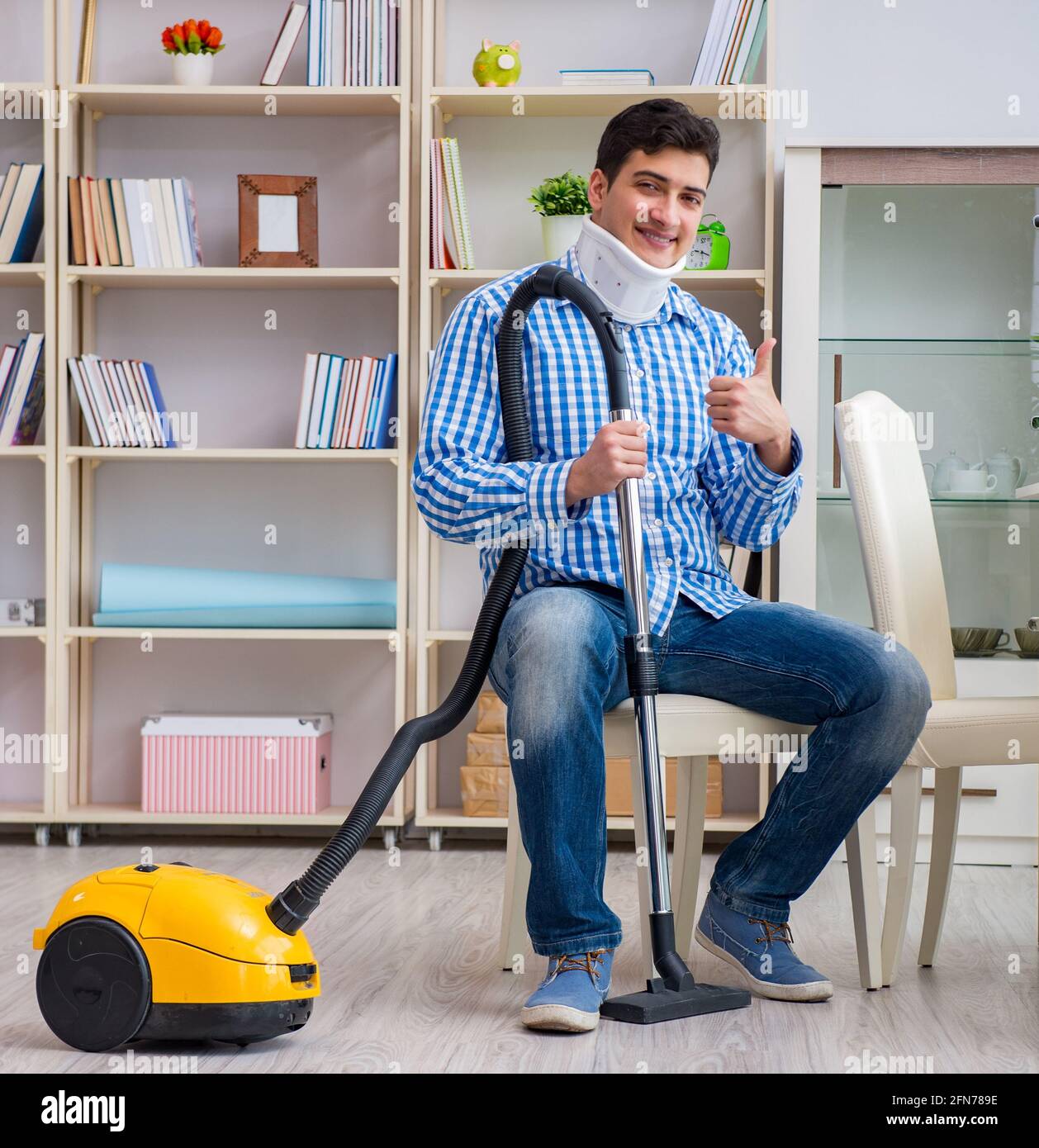 The injured man with neck injury vacuum cleaning house Stock Photo - Alamy