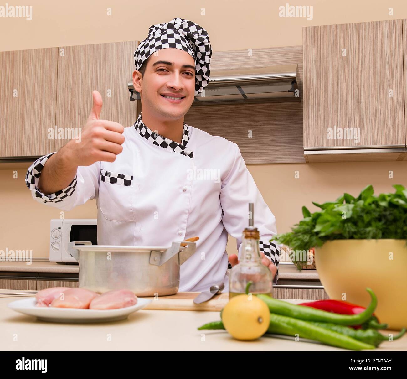 The young chef working in the kitchen Stock Photo - Alamy