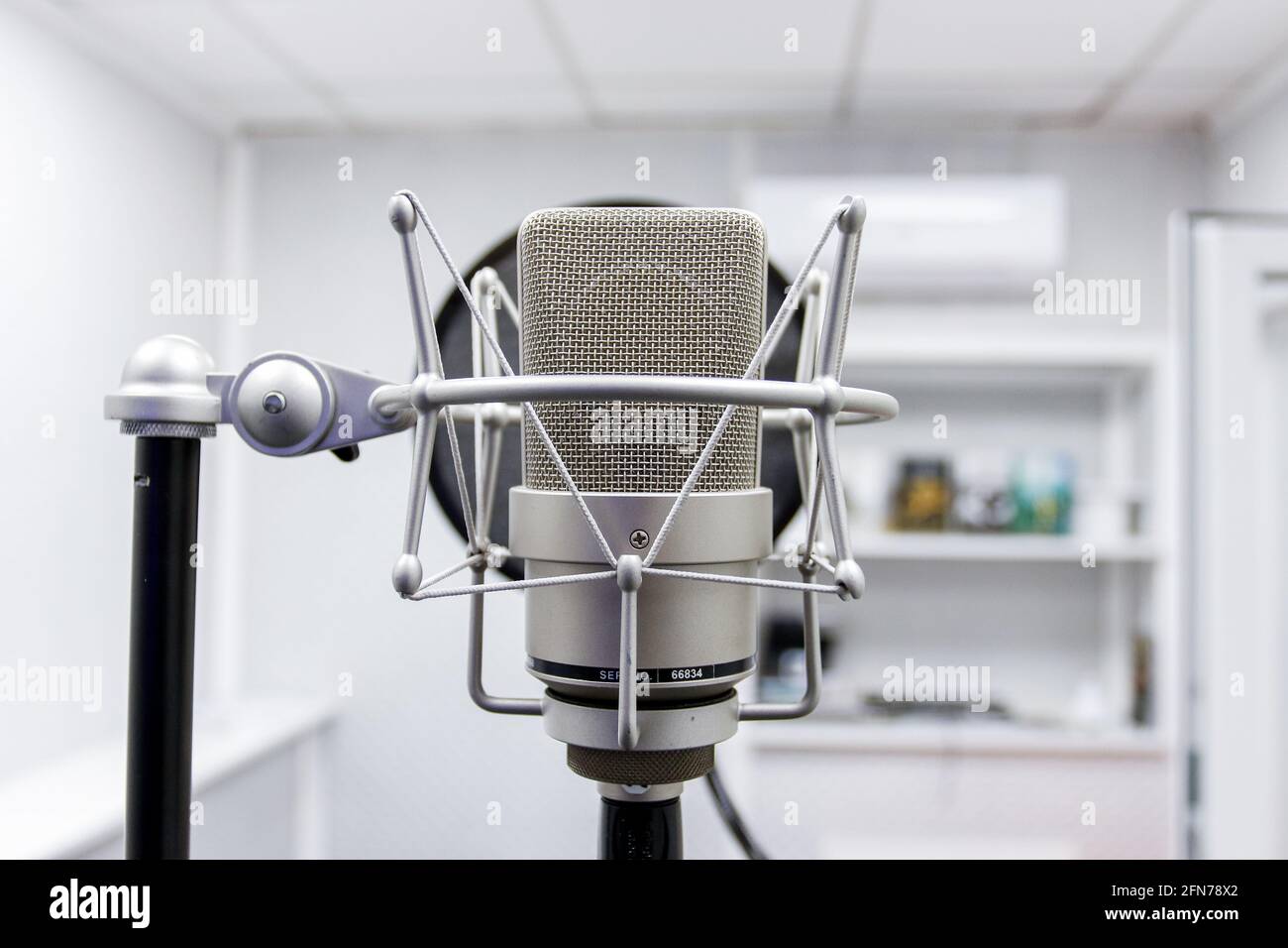 Professional microphone on the background of the light wall. Studio ...