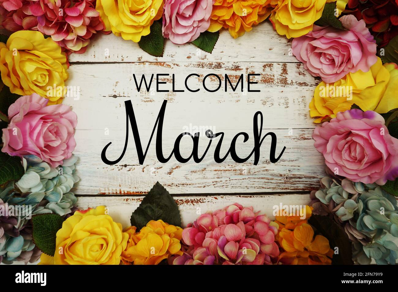Welcome March text message with flowers border decoration on wooden ...