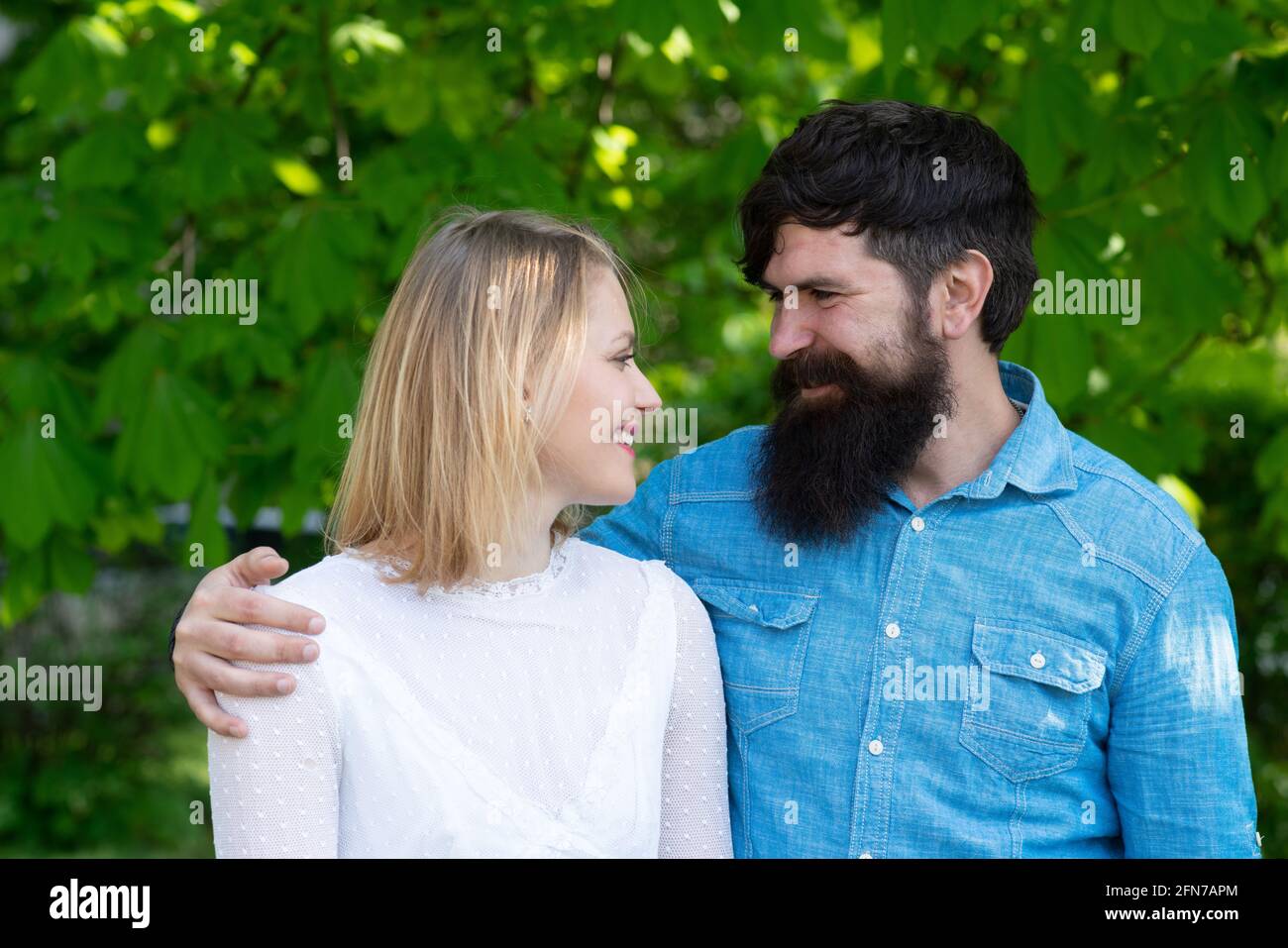 Spring Love. Couple looks each other outdoor. Summer walk in park Stock ...