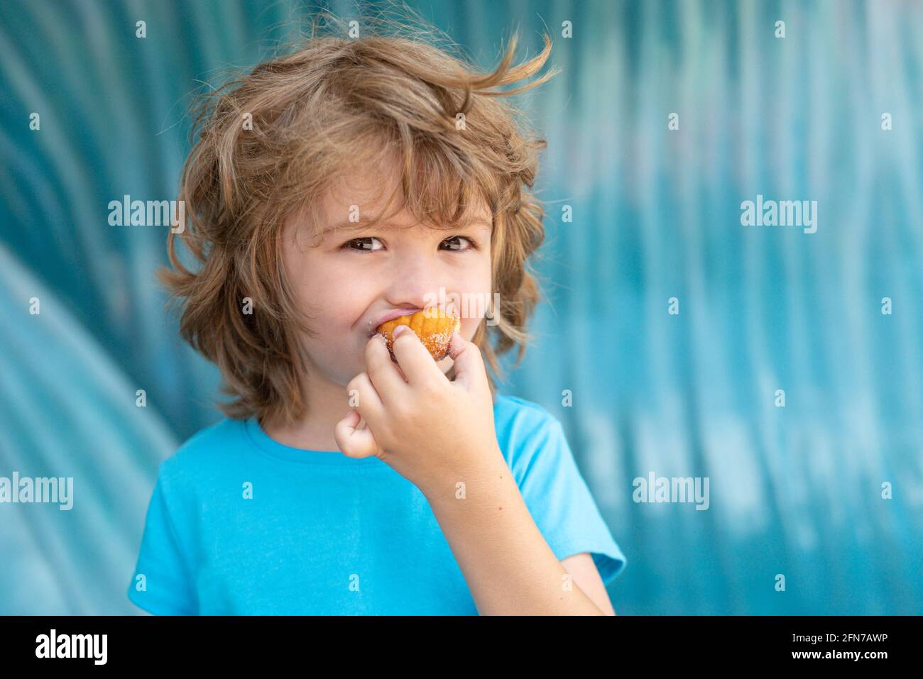Kid eating cookies outdoors. Child eats biscuit. Kids lunch Stock Photo ...