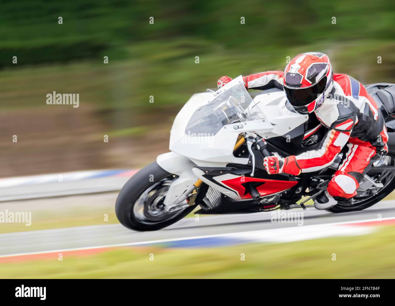 Motorcycle racer accelerating speed in track Stock Photo - Alamy