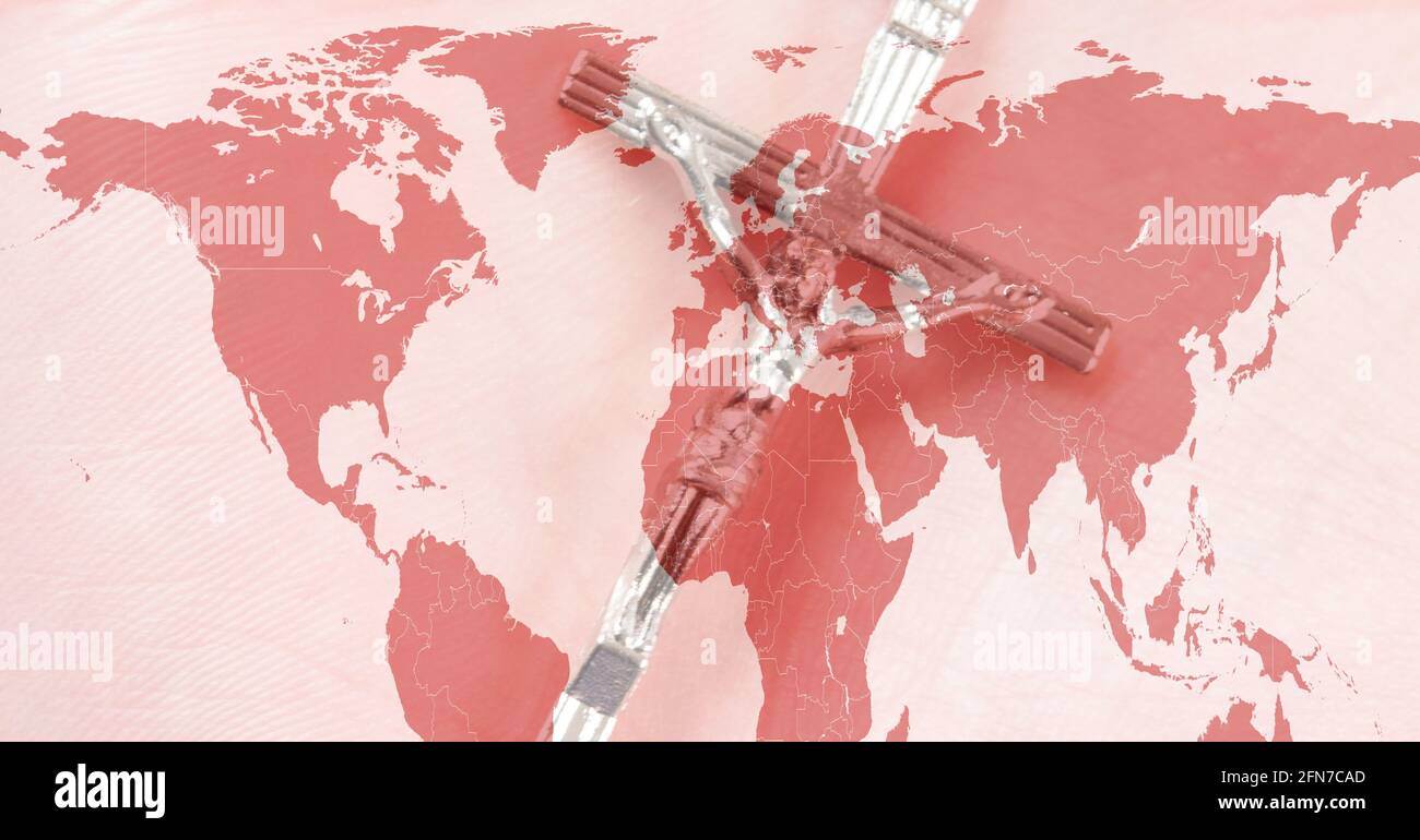 Composition of silver christian cross over world map on pink background ...
