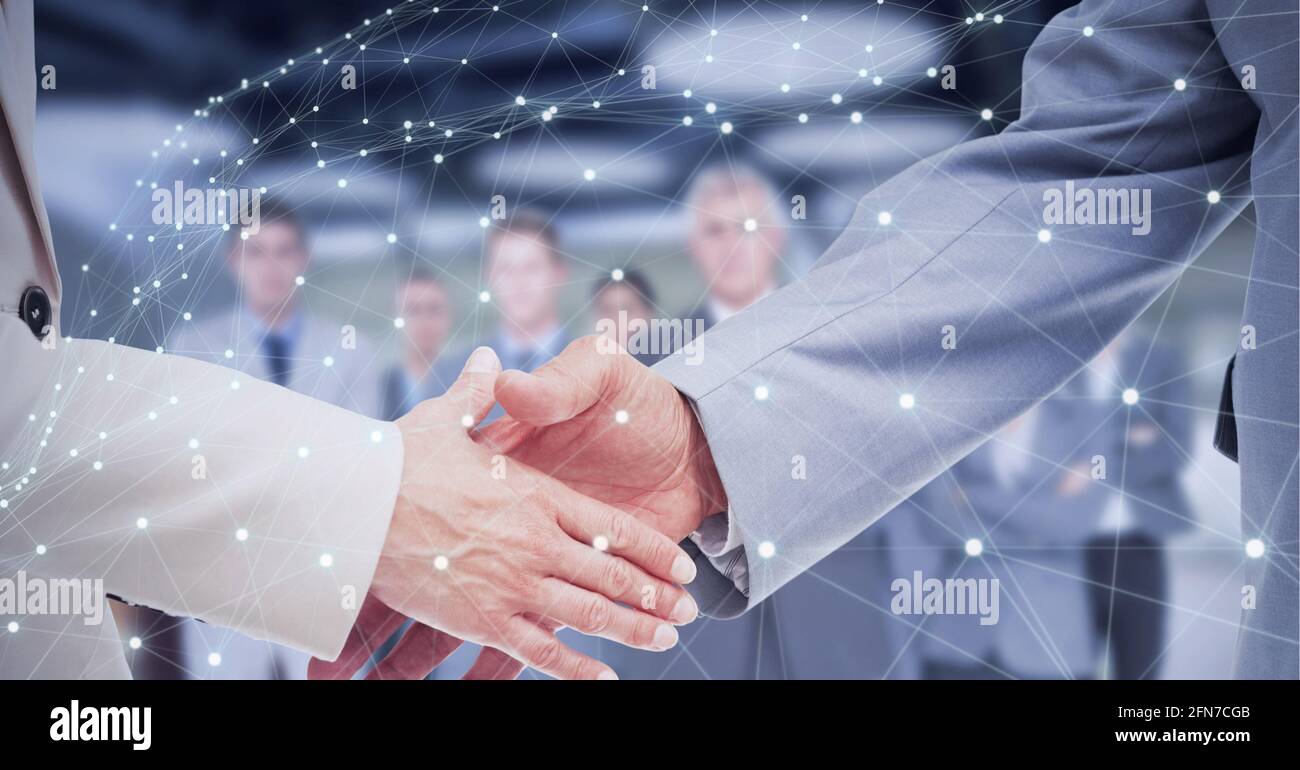 Network of connections over two businessmen shaking hands against ...