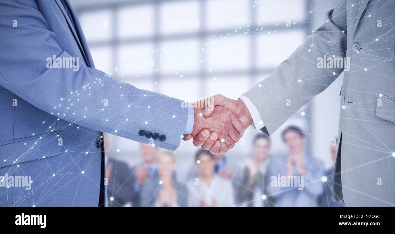 Network of connections over two businessmen shaking hands against ...