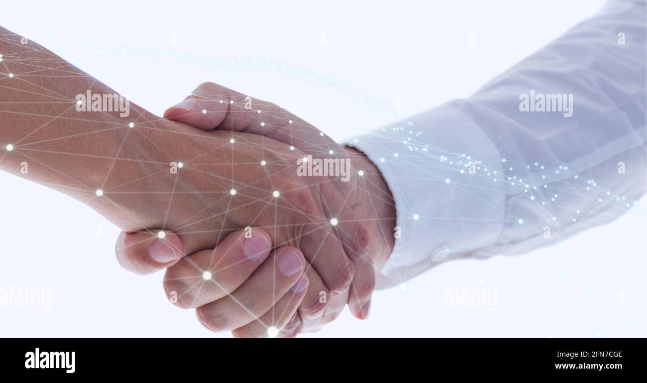 Network of connections over businessman and businesswoman shaking hands ...
