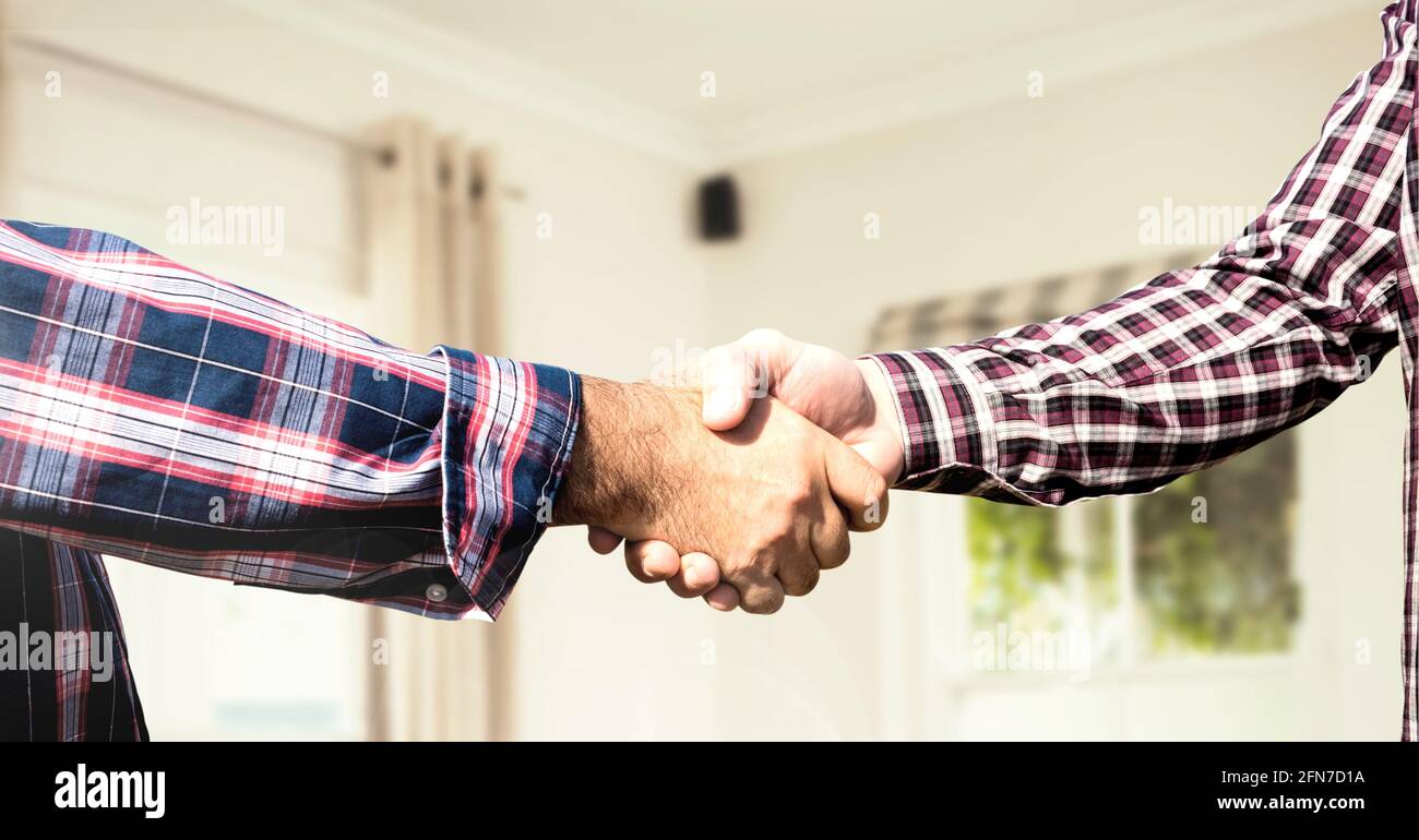 Composition of men shaking hands at home Stock Photo - Alamy