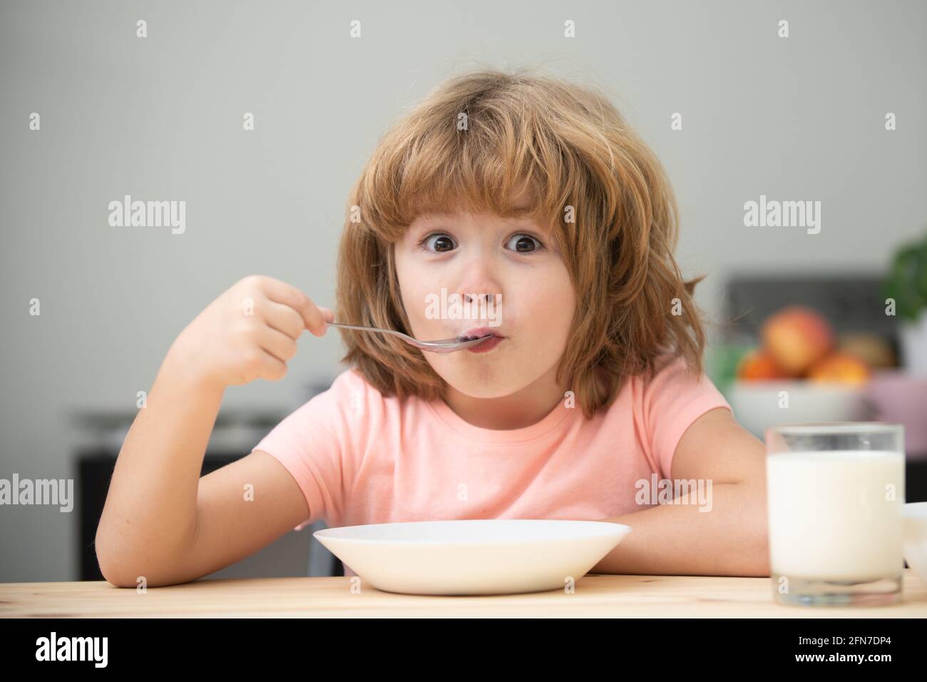 Caucasian toddler child boy eating healthy soup in the kitchen. Healthy ...