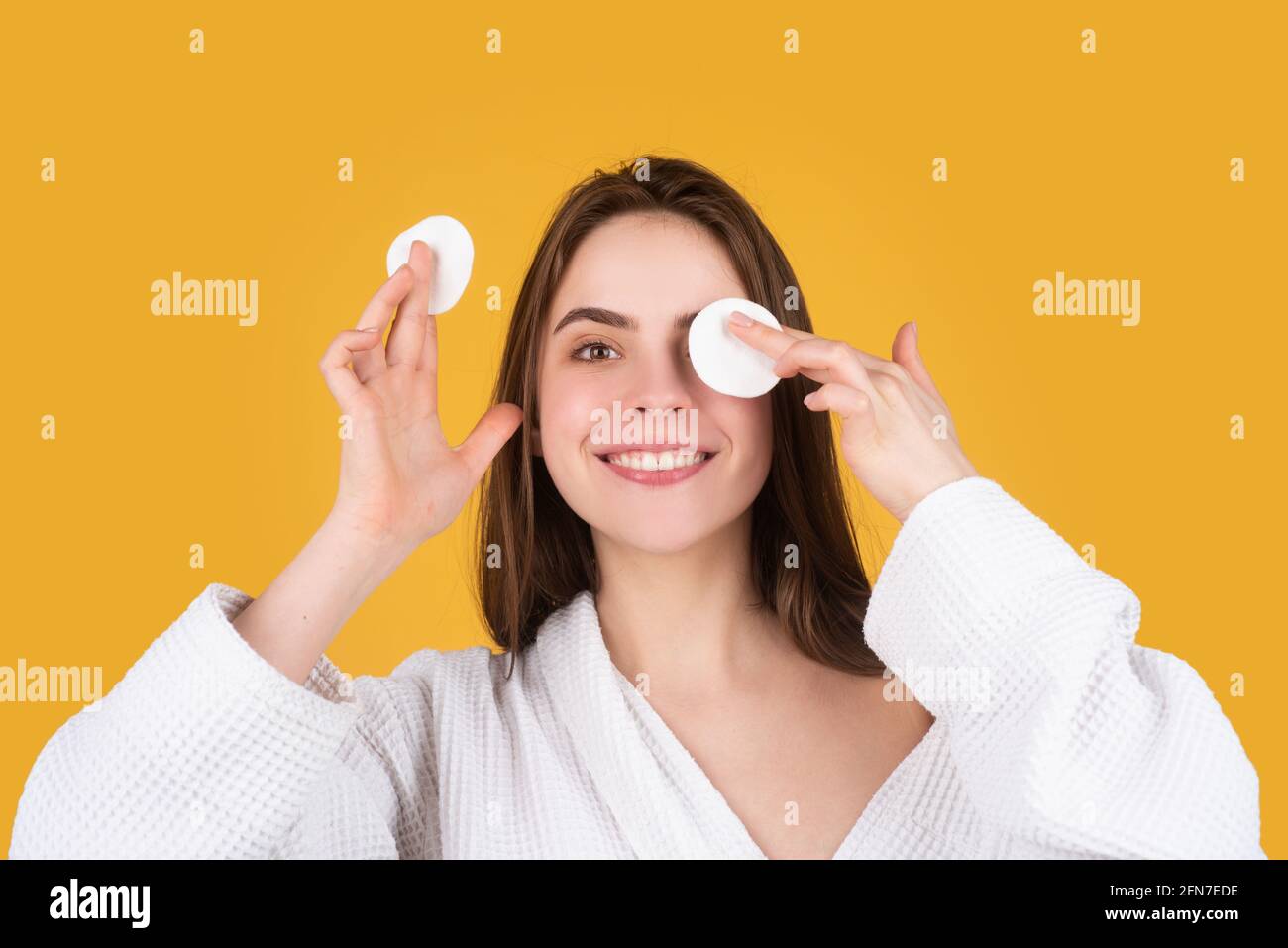Woman taking off makeup with cotton wipe sponge. Beautiful girl model ...