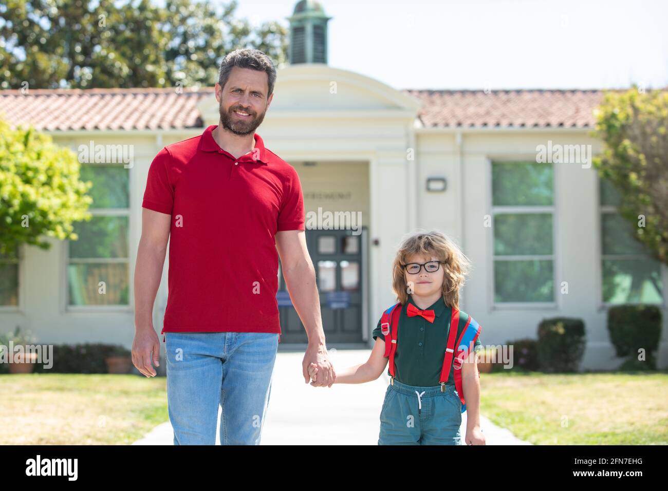 American father and son walking trough school park Stock Photo - Alamy