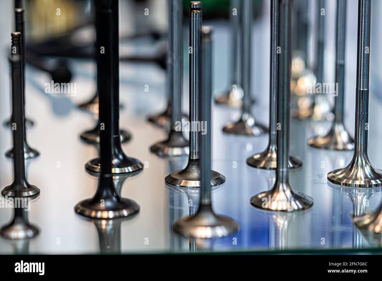 abstract background with car engine valves in a glass showcase, close ...